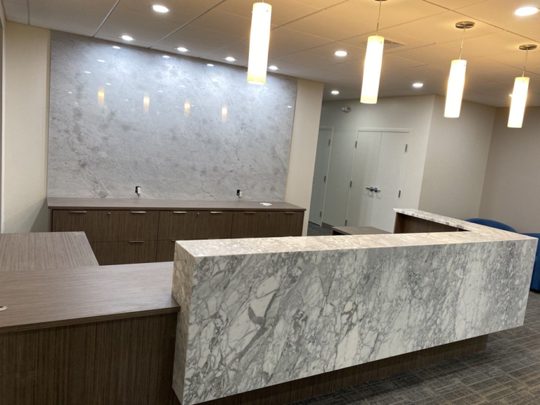 marble facade reception desk and wall corp office Montes Marble Granite ...
